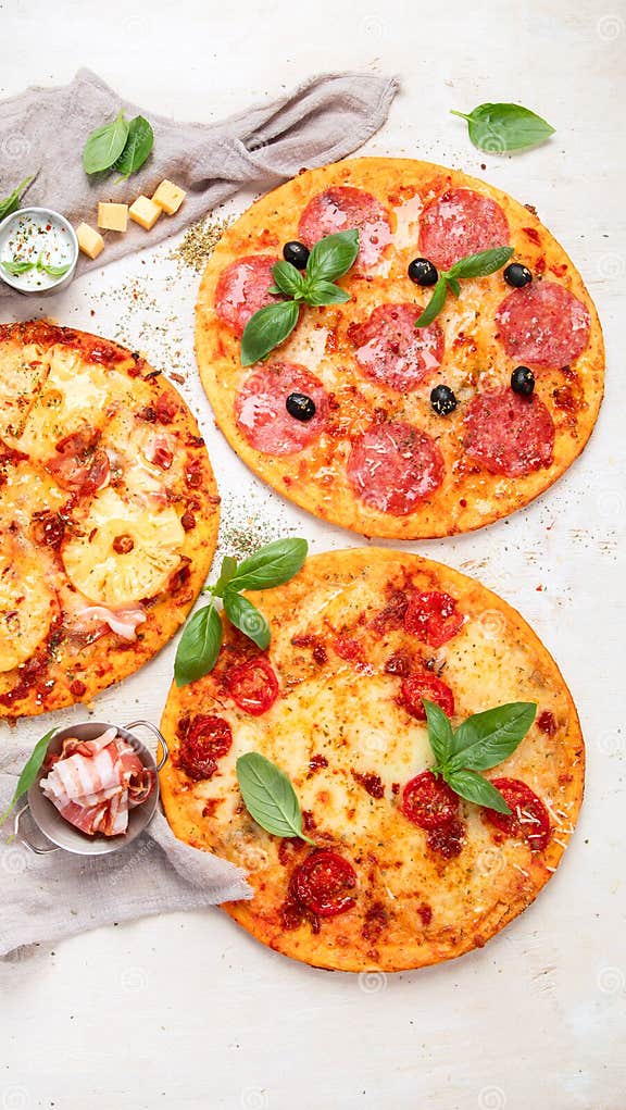 Different Types of Italian Pizza on Light Background Stock Photo ...