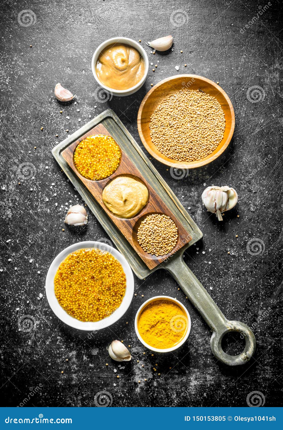 Different Types of Mustard in Plates and on a Stand with Garlic Slices ...
