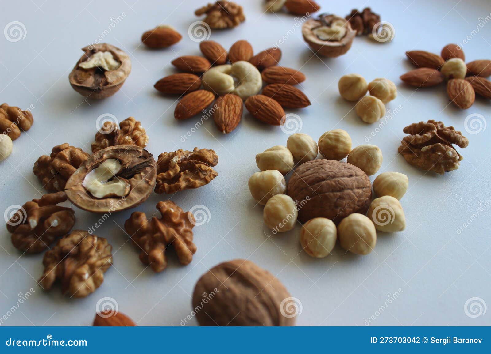 Different Types of Nuts in Form of Flowers on White Surface Angle View ...