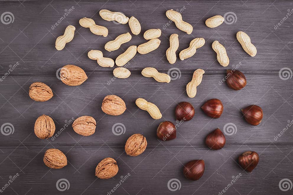 Different Types of Nuts: Walnut, Peanut, Chestnut on Wooden Stock Photo ...
