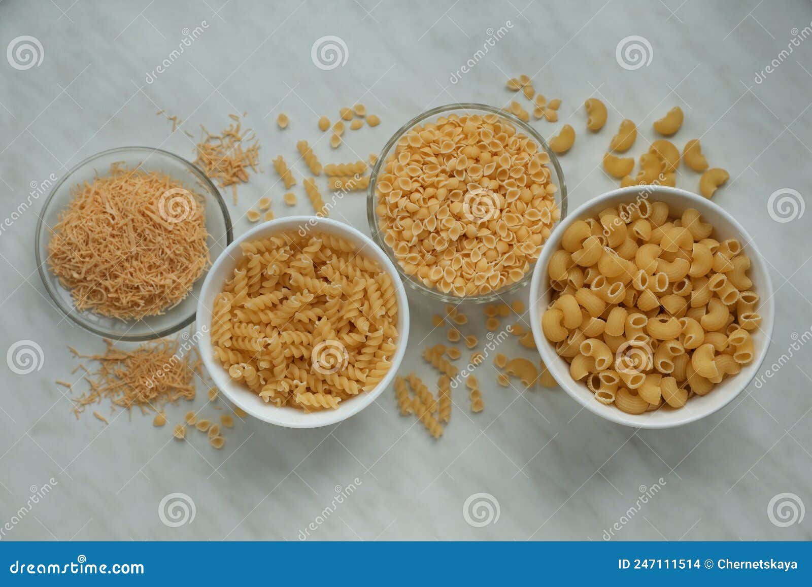 Different Types of Pasta on White Marble Table, Flat Lay Stock Photo ...