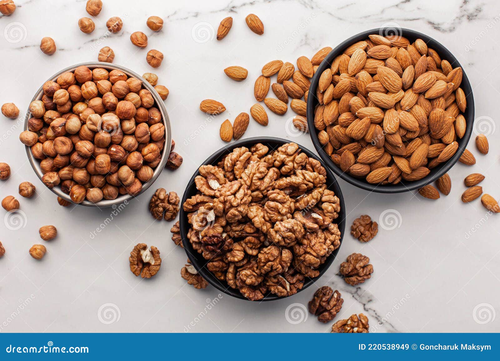 Different Types of Peeled Nuts in Bowls and a Few Nuts Scattered Around ...
