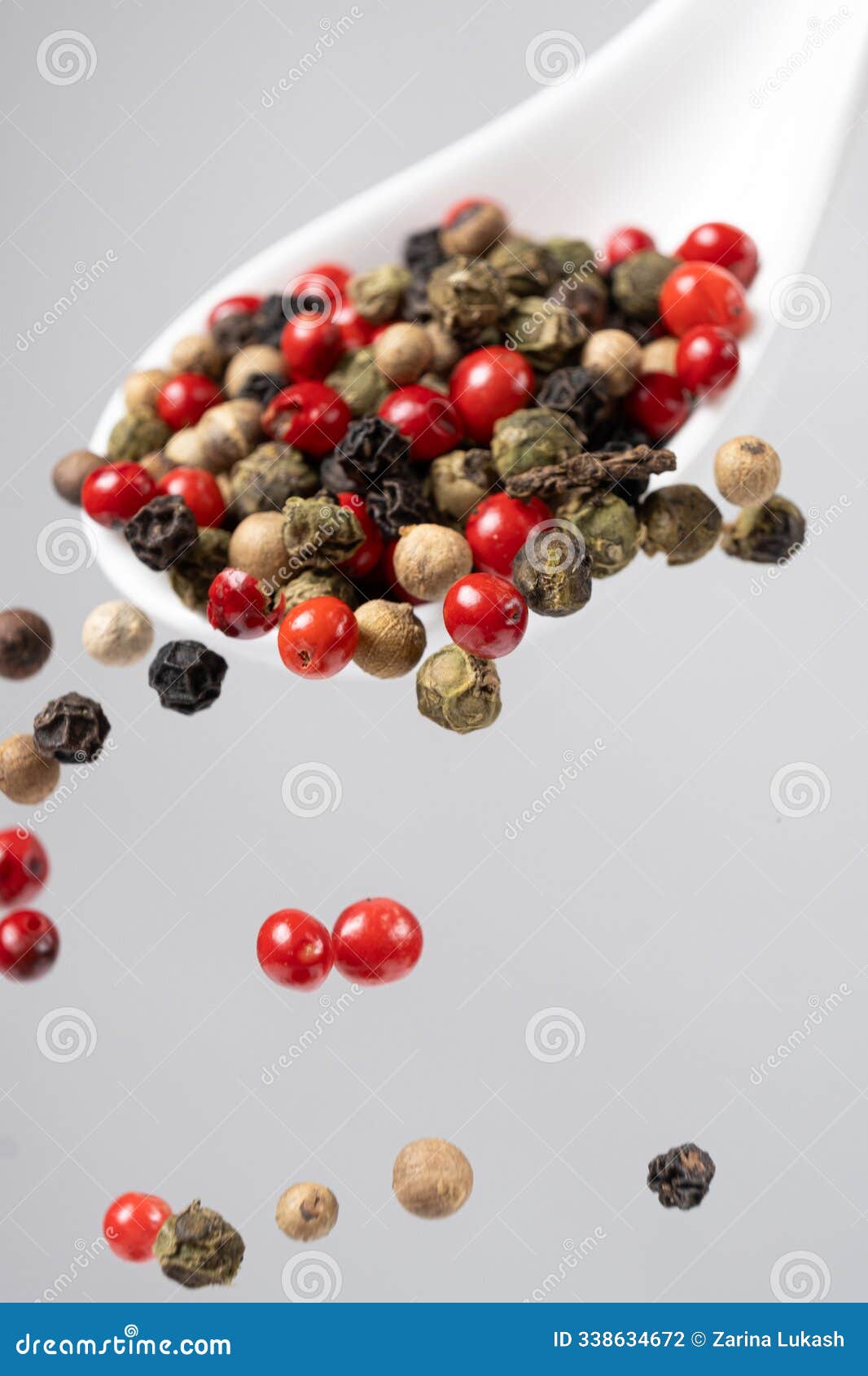 Different Types of Peppercorns Pouring. Red, Green, White and Black ...