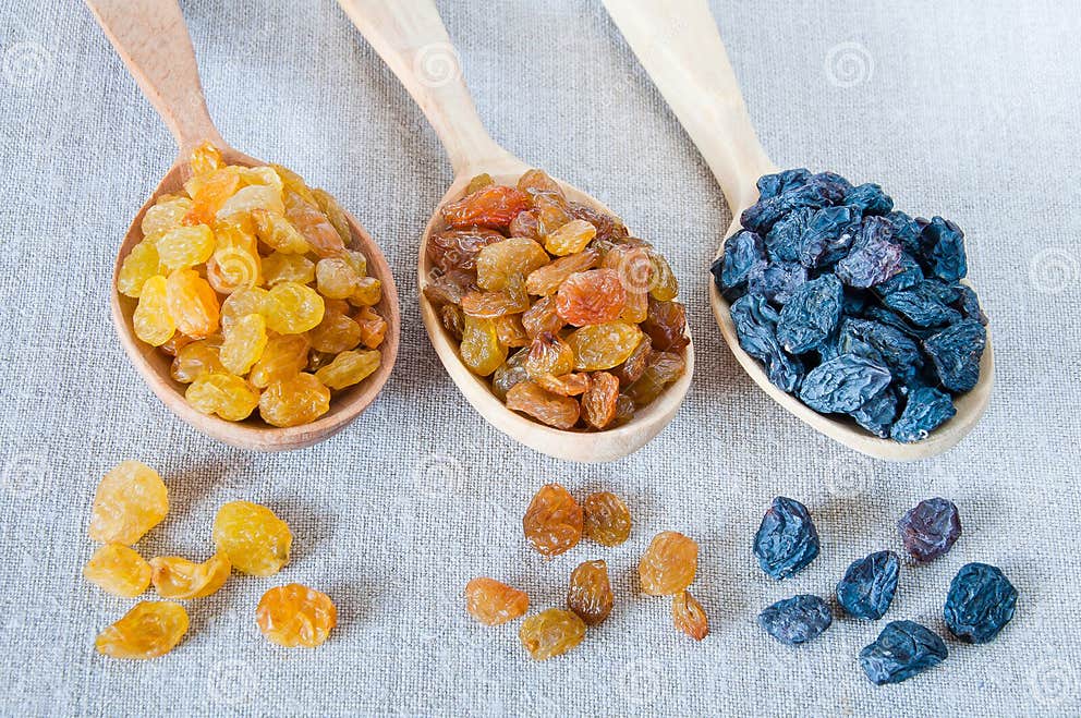 Different Types of Raisins on Wooden Spoons on Sacking Background Stock ...
