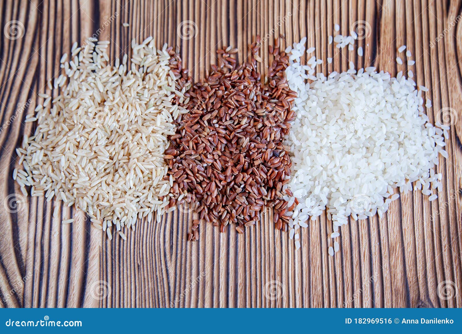 Different Types of Rice on a Wooden Background. White, Brown and Red ...