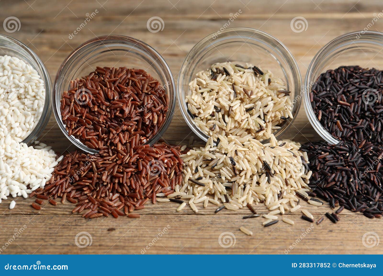 Different Types of Rice on Wooden Table, Closeup Stock Photo - Image of ...