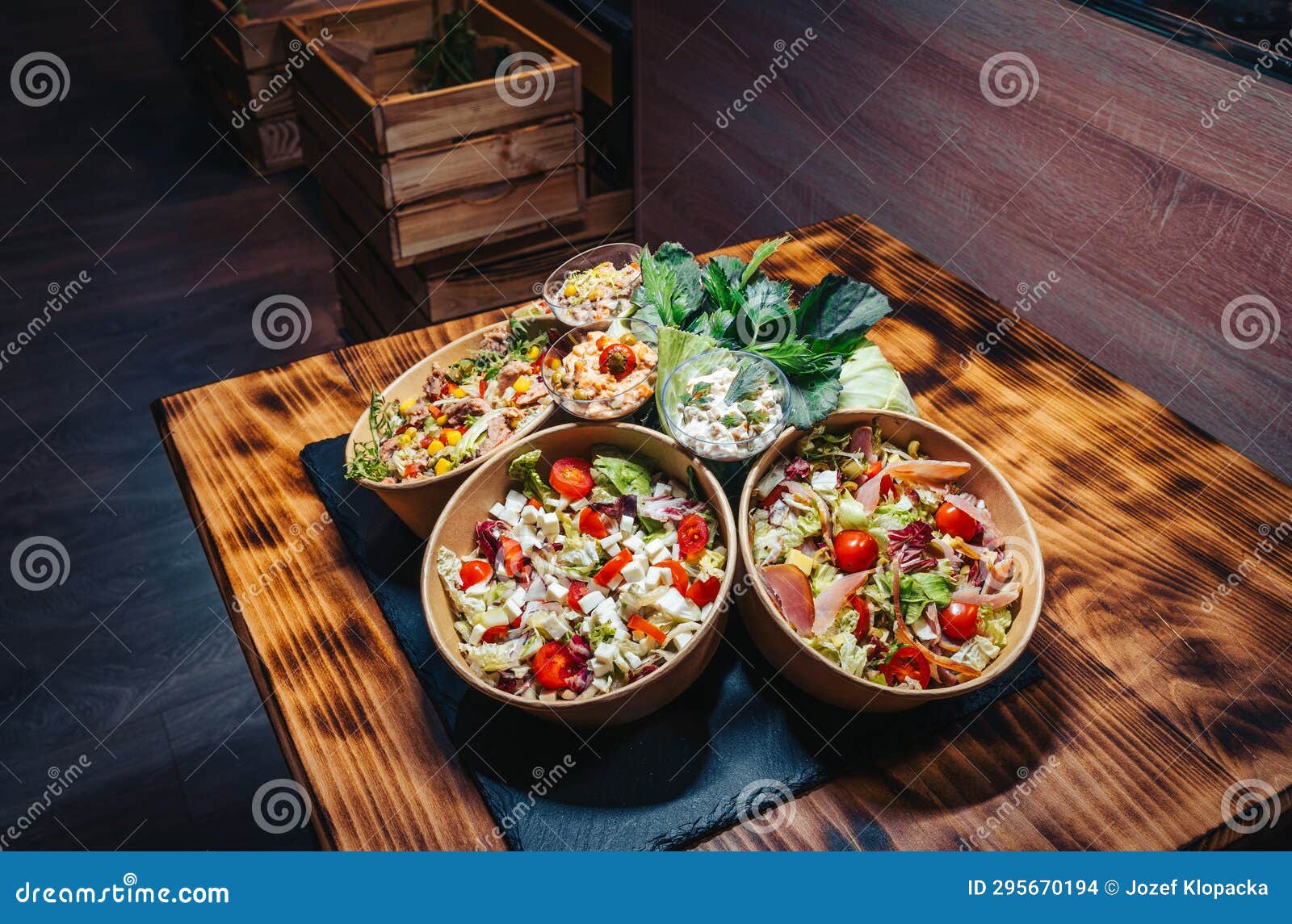 Different Types of Salads in a Bowl on a Wooden Table in a Restaurant ...