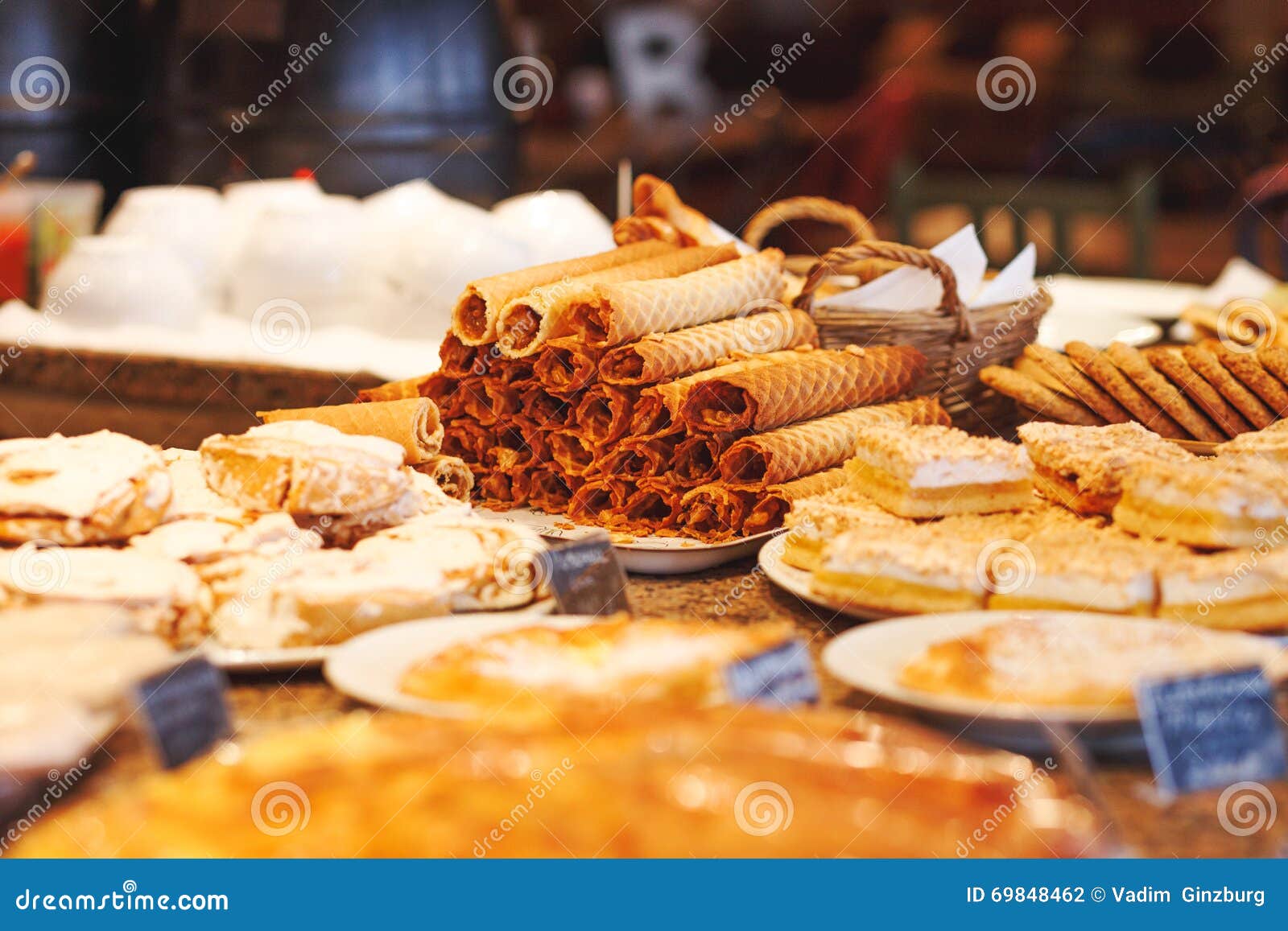 Different Types of Sweet Pastries on Plates at Counter Cafe Stock Photo ...