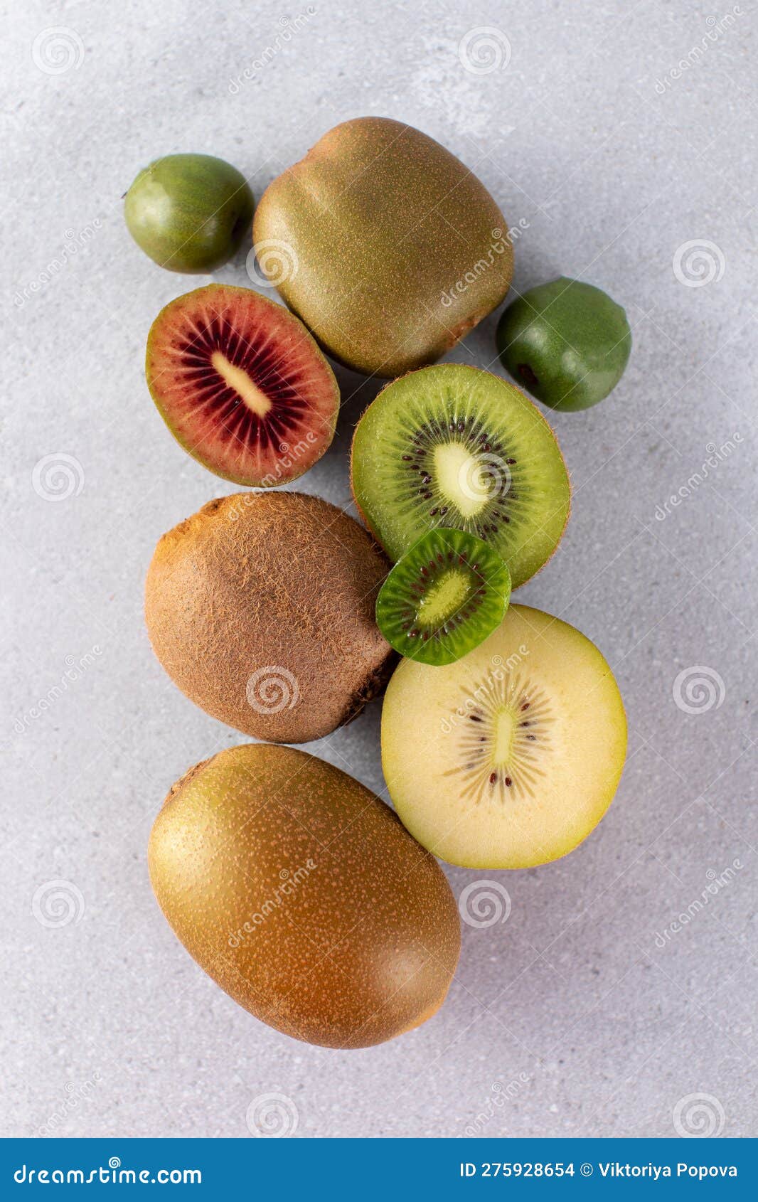 Different Varieties of Kiwi Lie in a Pile on the Table. Halves of Red ... Different Varieties of Kiwi Lie in a Pile on the Table. Halves of Red ...