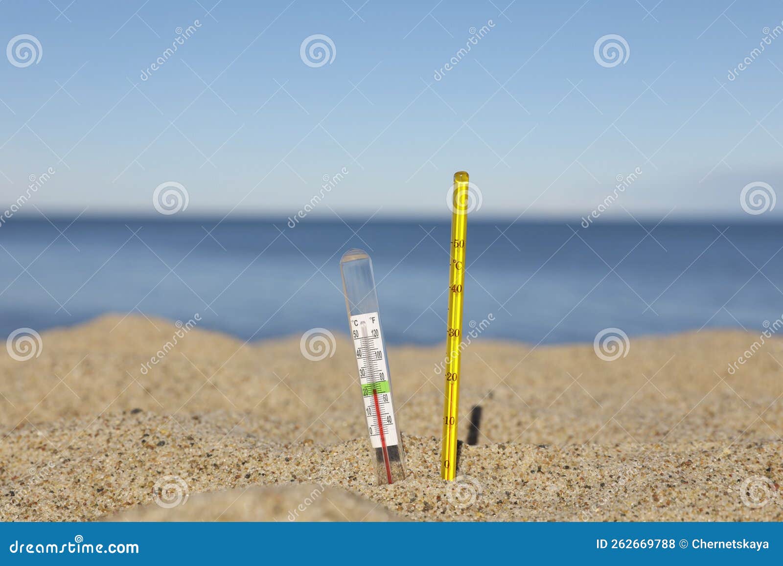 Different Weather Thermometers in Sand Near Sea Stock Photo - Image of ...