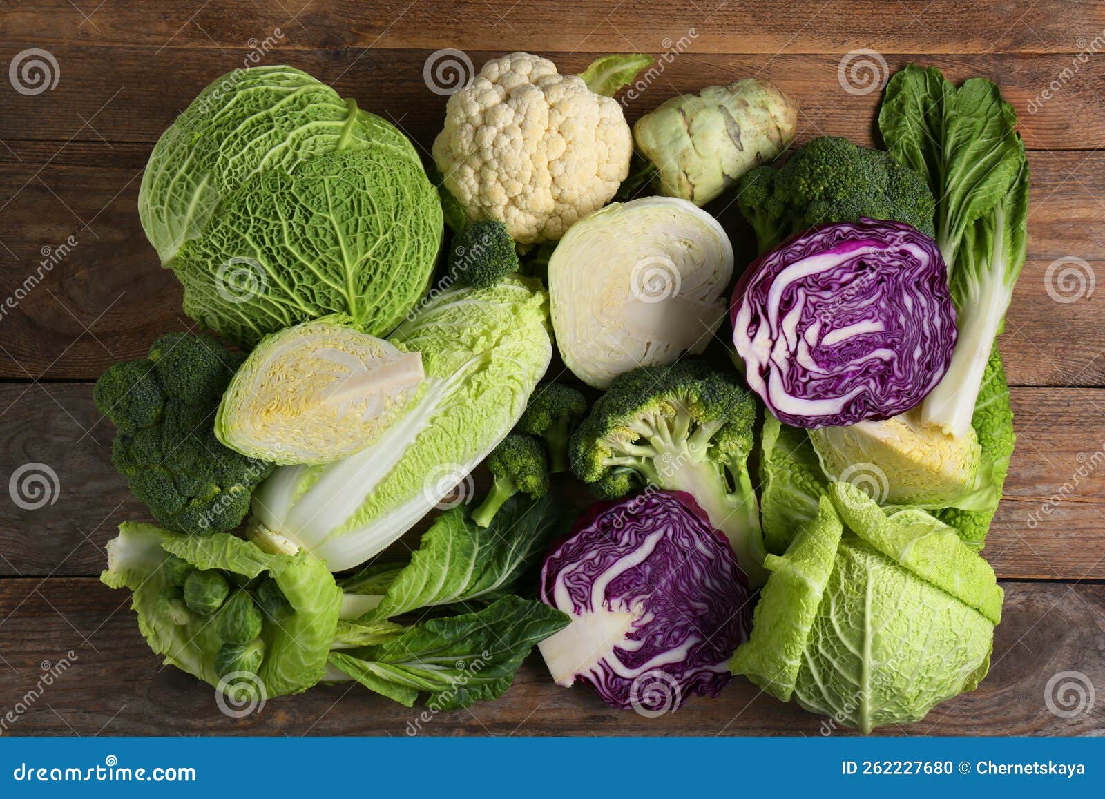 Different Whole and Cut Types of Cabbage on Wooden Table, Flat Lay ...