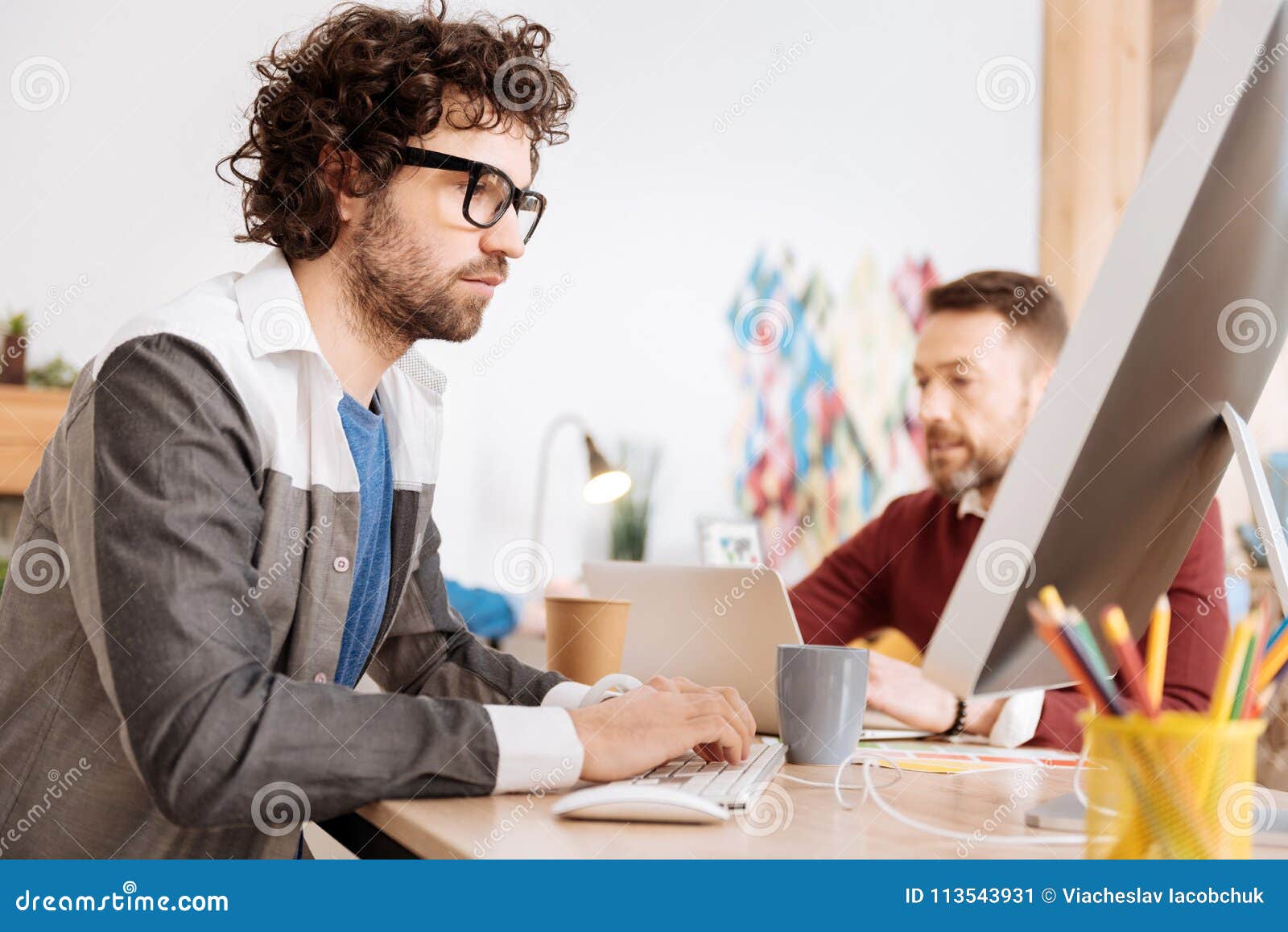 Serious Young Employee Working in the Office Stock Image - Image of ...