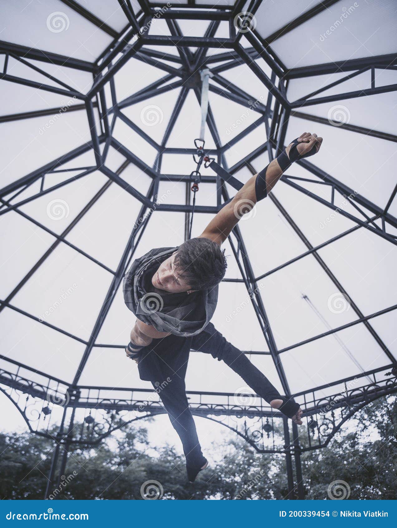 Difficult Training of Young Athlete on Strings Above Dome of Light ...