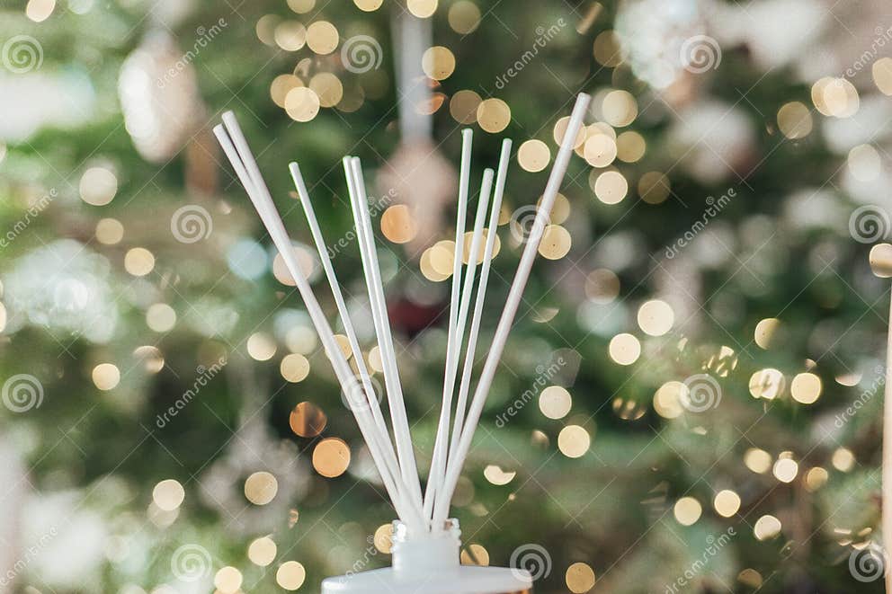 Diffuser with Sticks with Aroma on Christmas Shining Tree Background ...