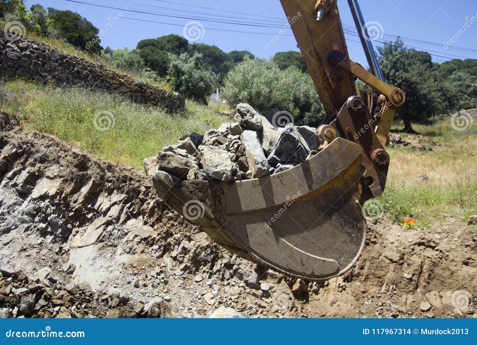 Digger Bucket Full of Rocks Stock Photo - Image of industrial, excavate ...