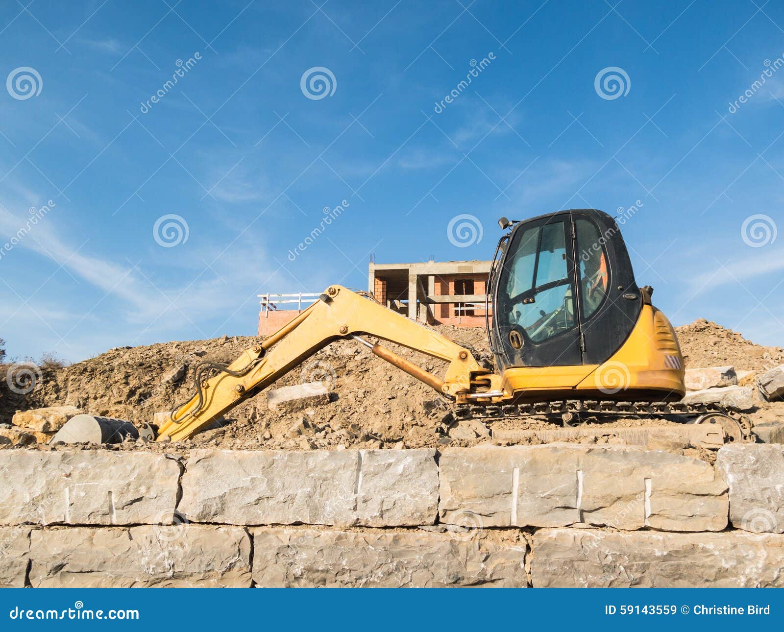 Digger on a Construction Site Building a Stone Wall Stock Image - Image ...