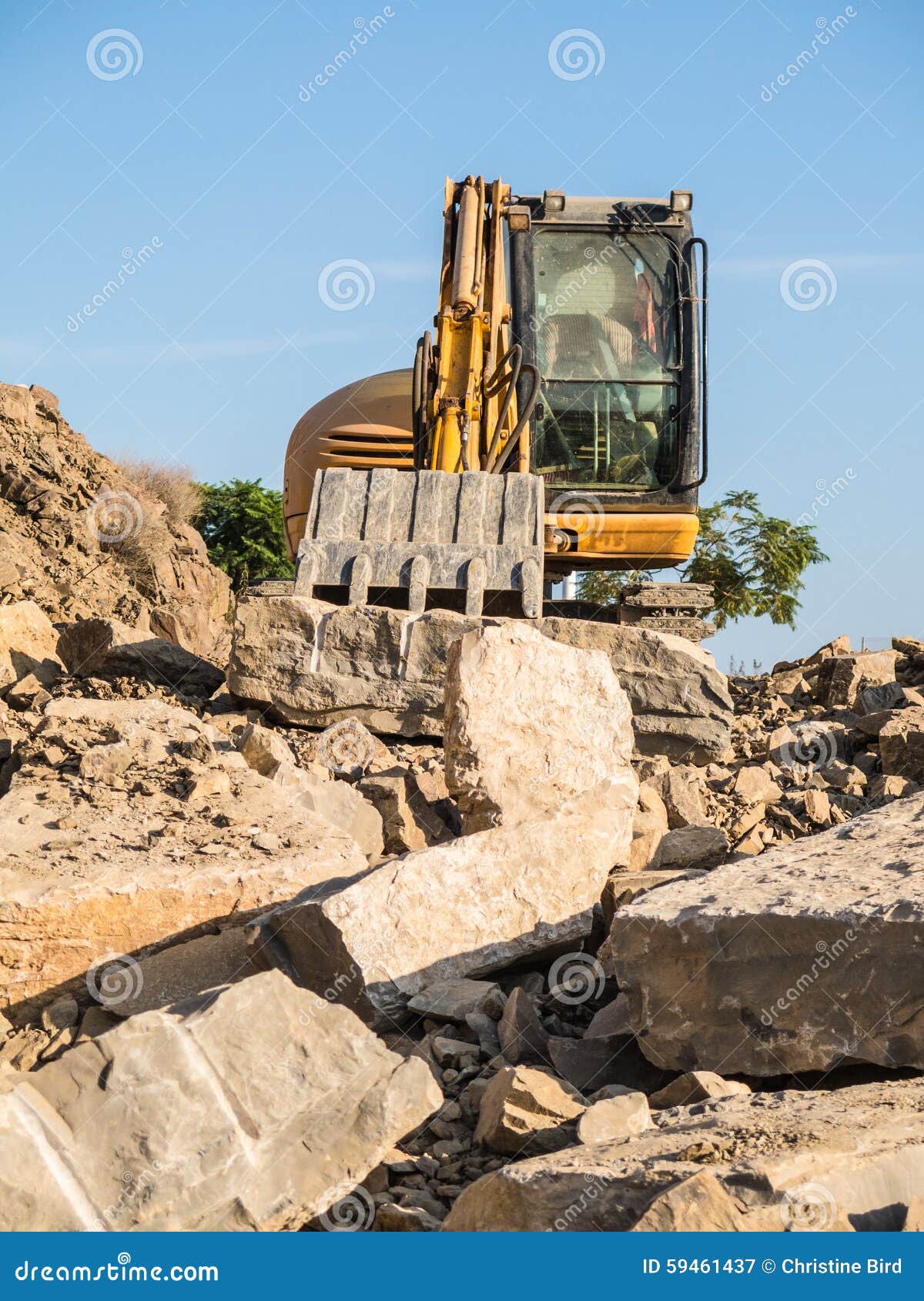 Digger on a Construction Site Building a Stone Wall Stock Image - Image ...