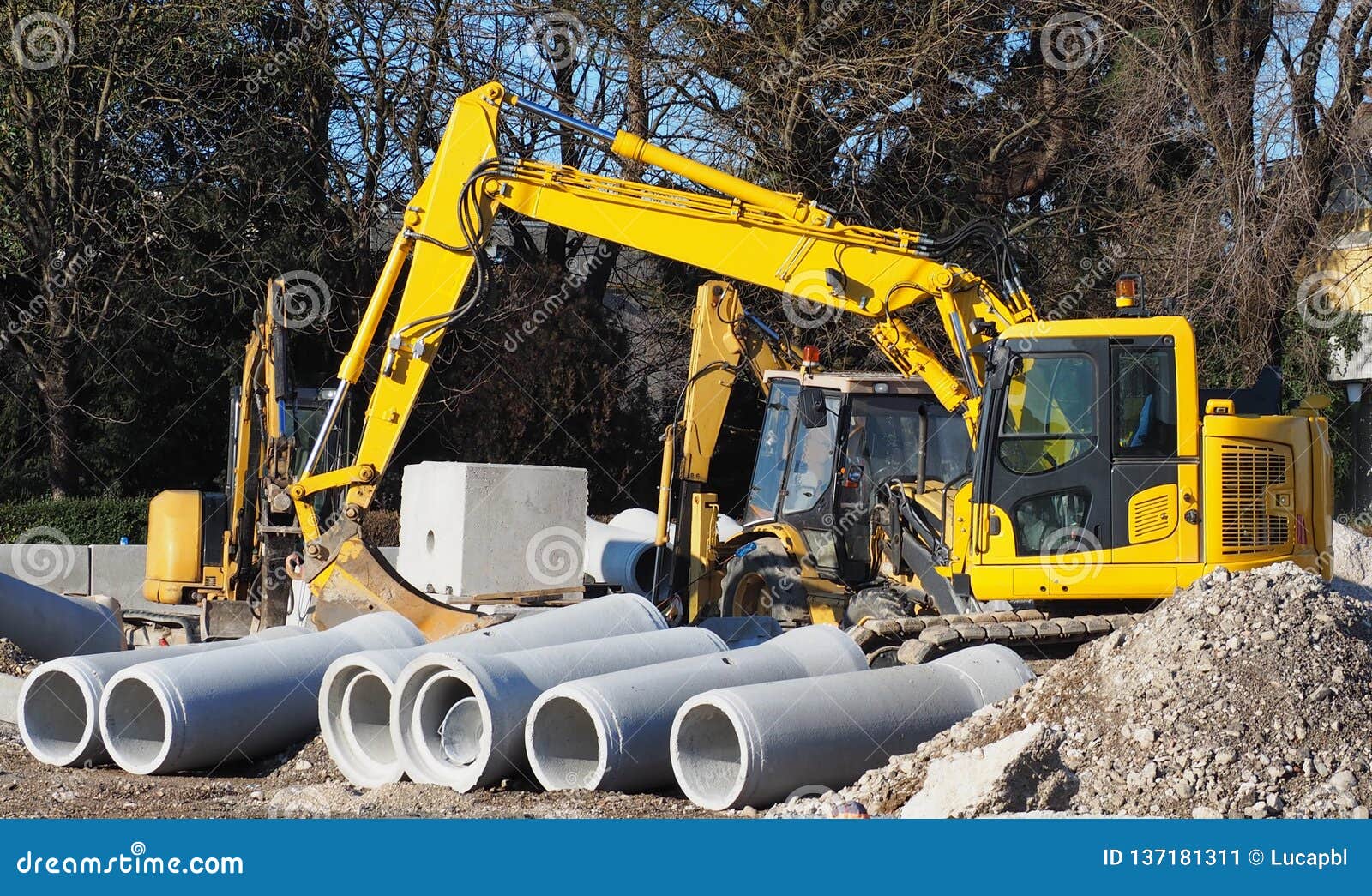 Digger, Mini Excavator and Dozer in a Road Construction Site. Pipes ...