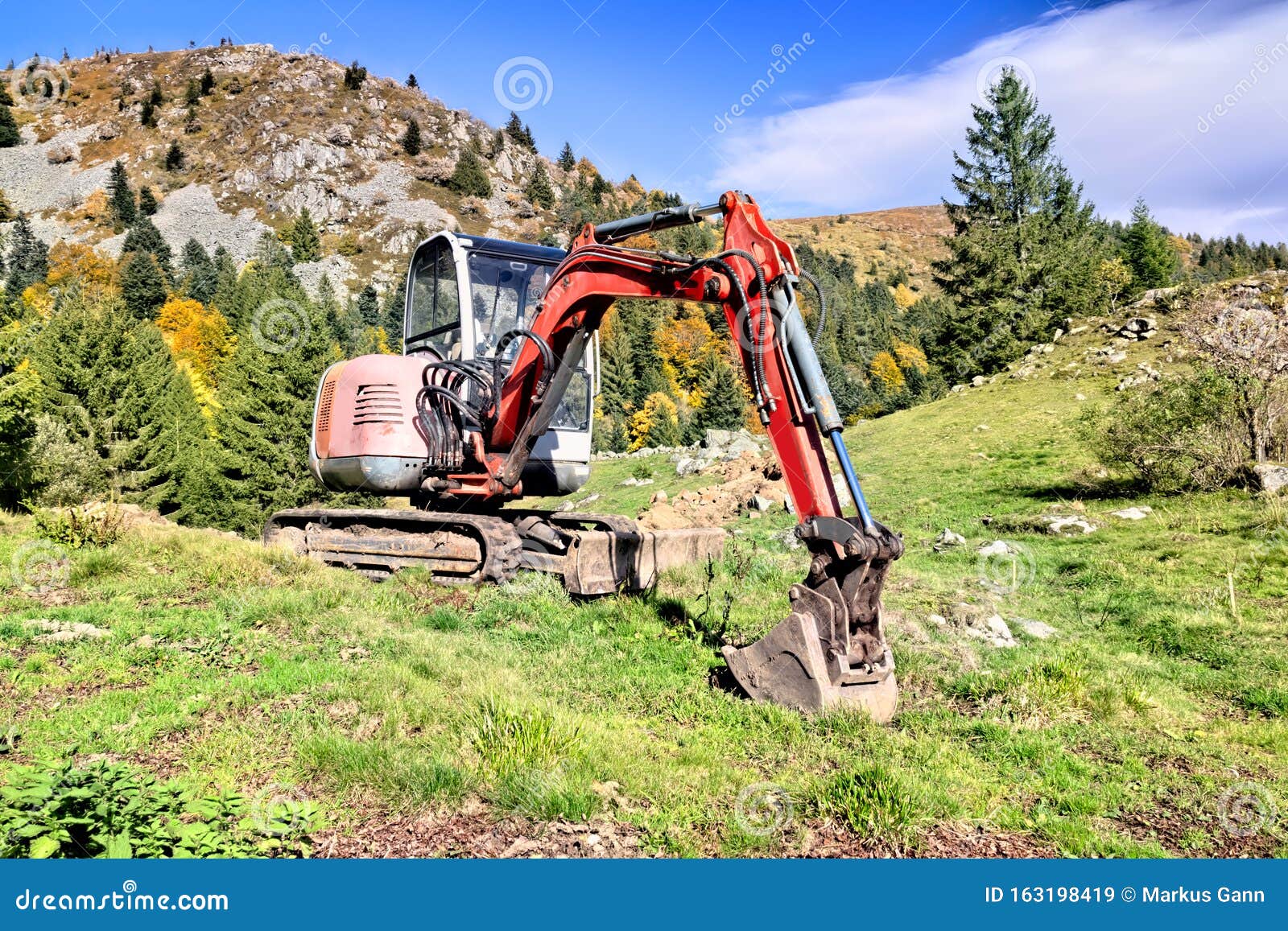A digger in the mountains stock image. Image of building - 163198419