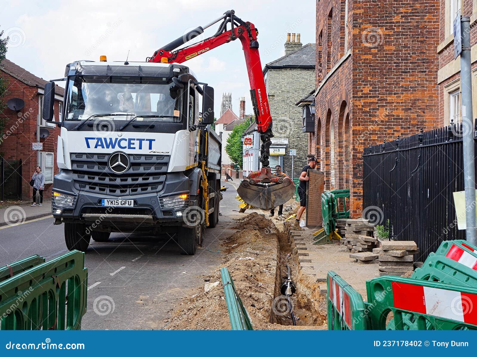 Digger Truck Digging a Hole in the Pavement for Essential Repairs ...