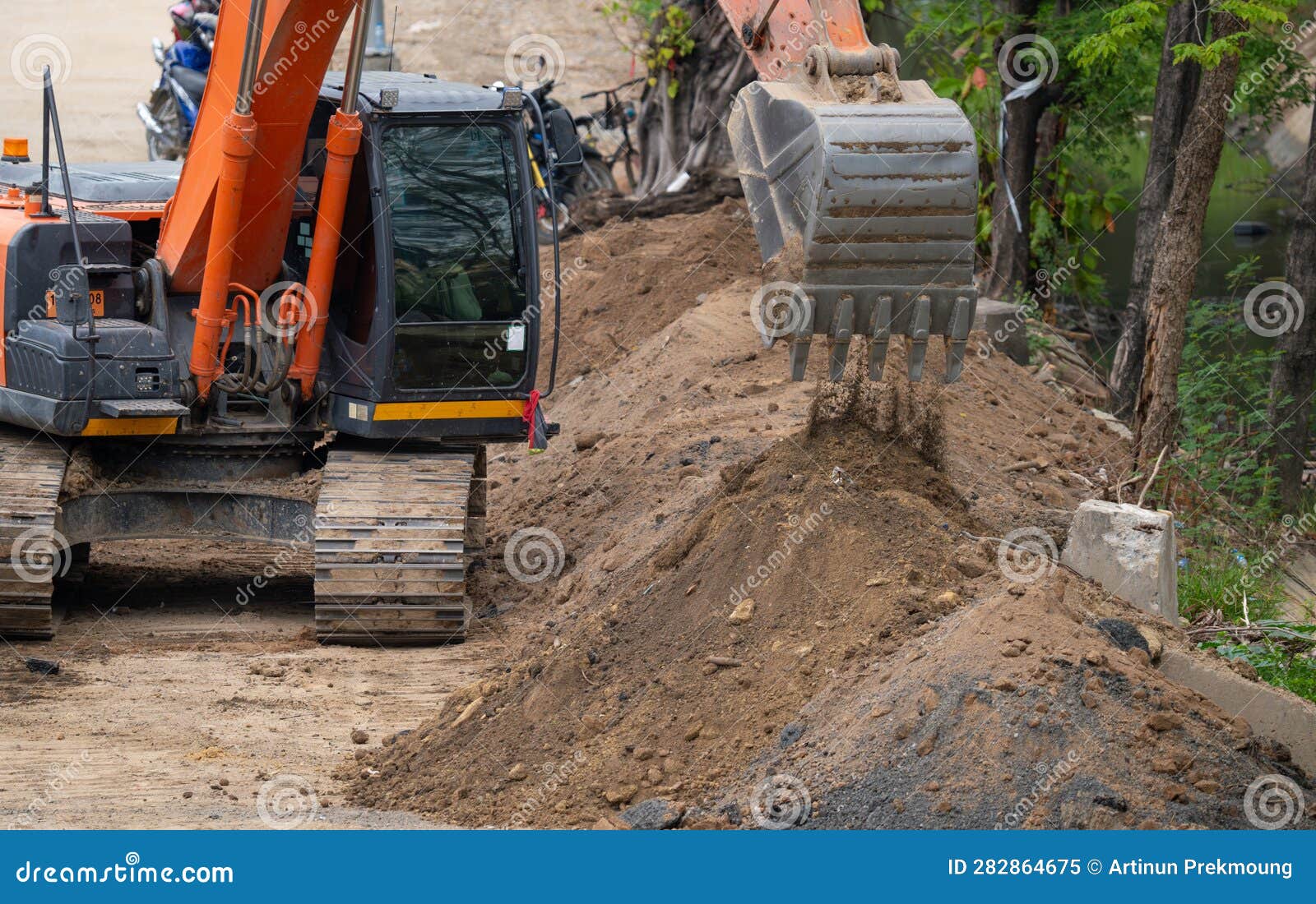 Digger Working by Digging Soil at Construction Site. Bucket Teeth of ...