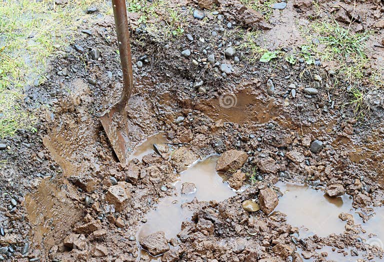 Digging a hole in the mud stock image. Image of drainage - 21059361