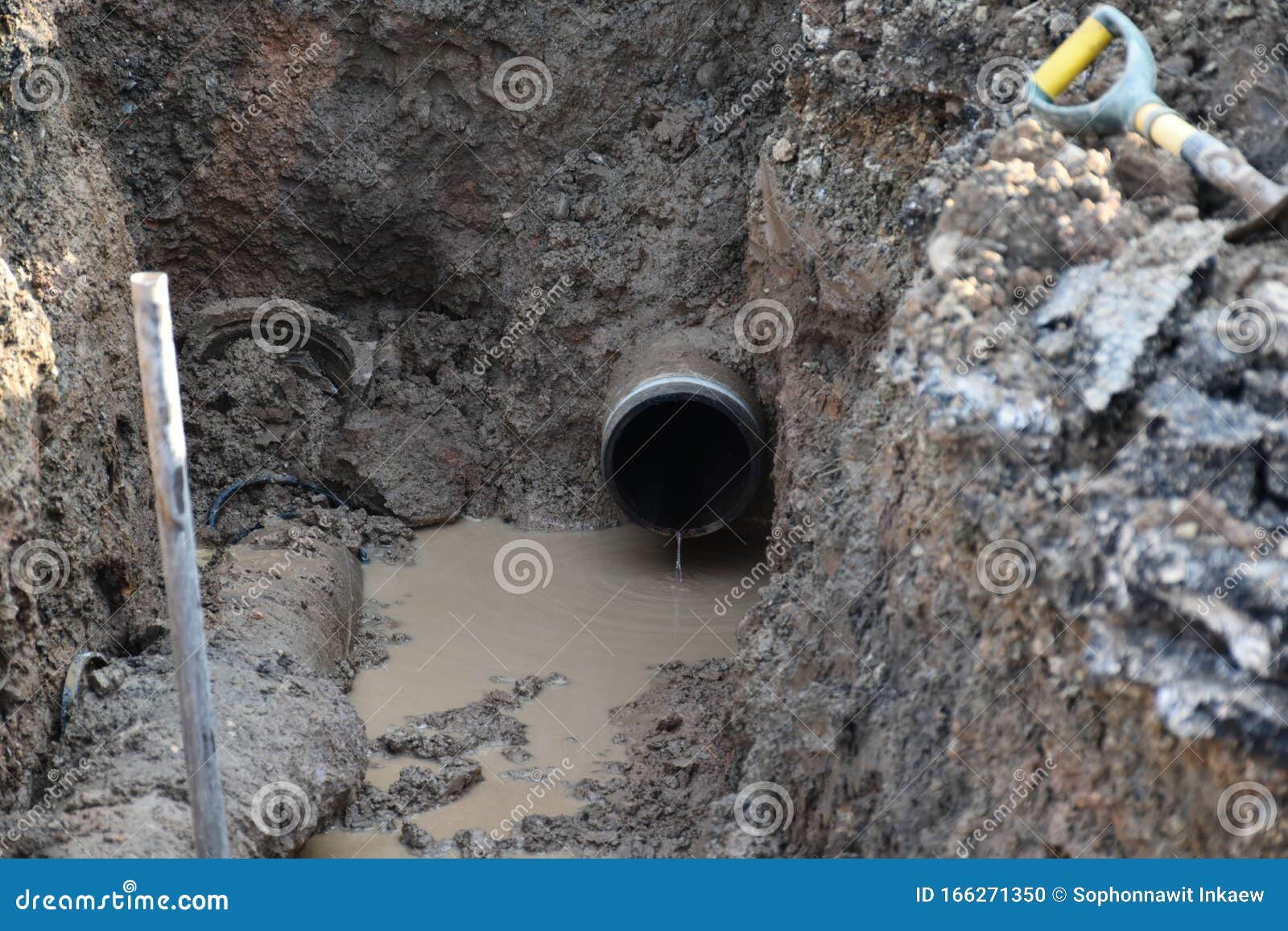 Digging hole of a pipe. stock photo. Image of pavement - 166271350