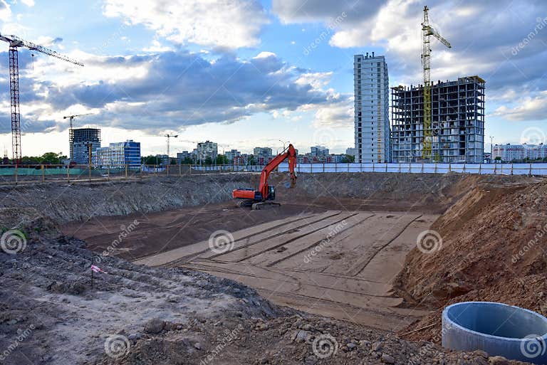 Digging the Pit Foundation a Hole with Excavator. Earthwork in ... Digging the Pit Foundation a Hole with Excavator. Earthwork in ...