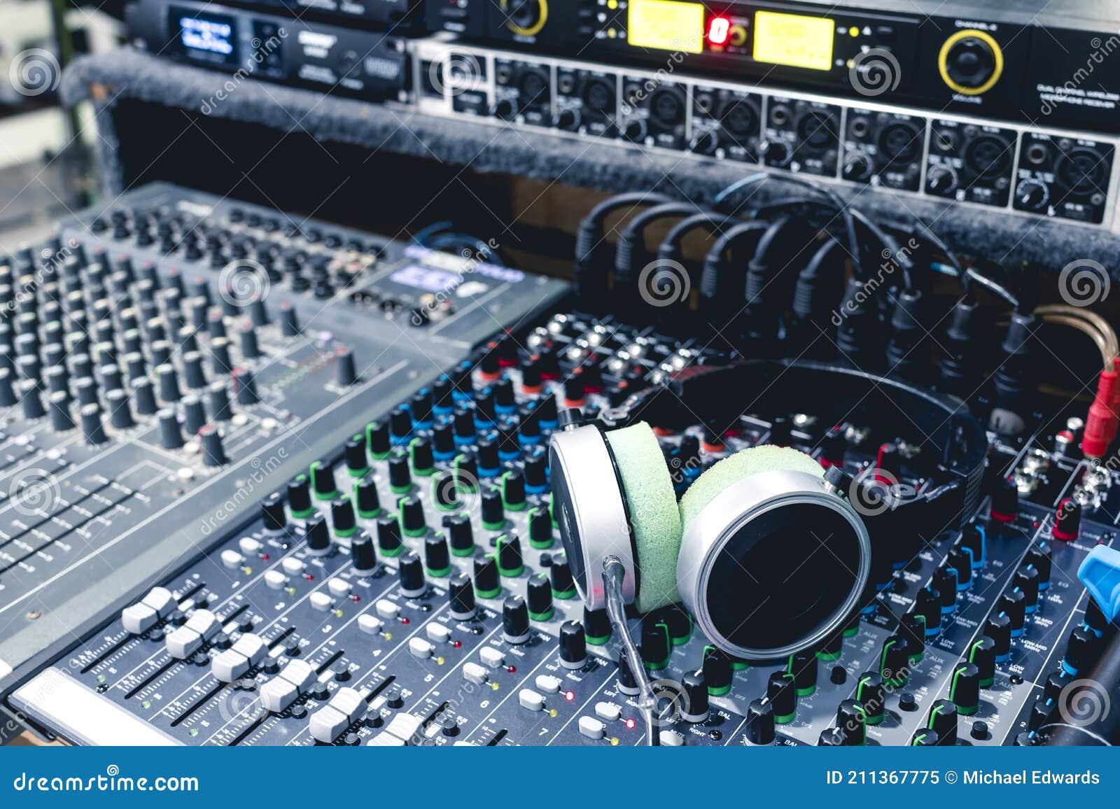 A Digital and Analog Mixer Placed Side by Side, with a Headset Placed ...