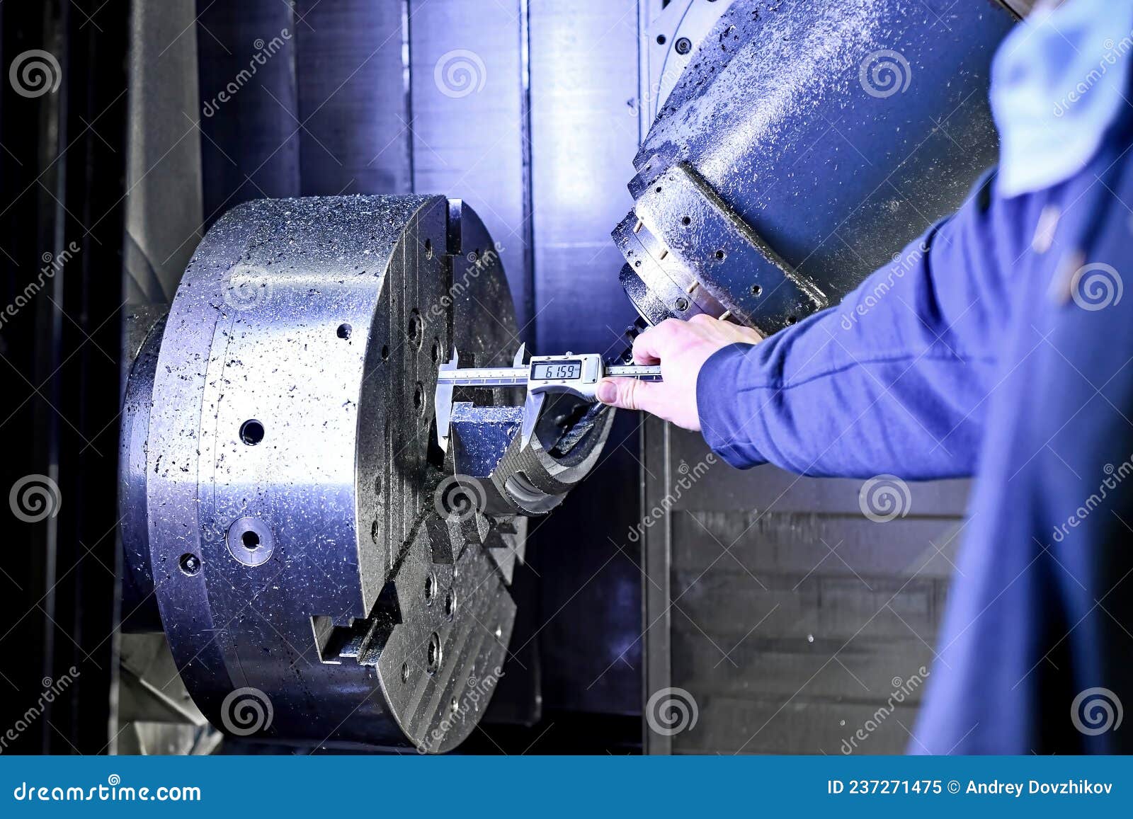 With a Digital Caliper, a Man Measures the Workpiece on a CNC Milling ...