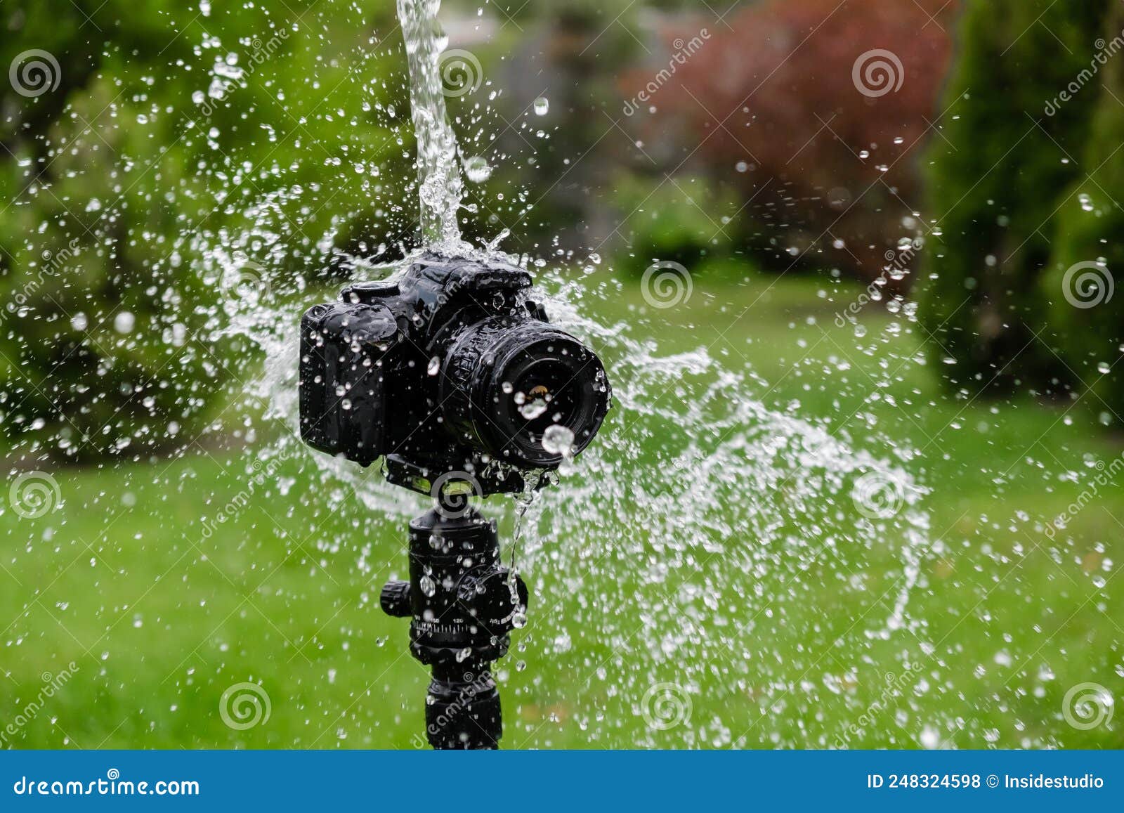 A Digital Camera on a Tripod in the Rain Stock Photo - Image of splash ...