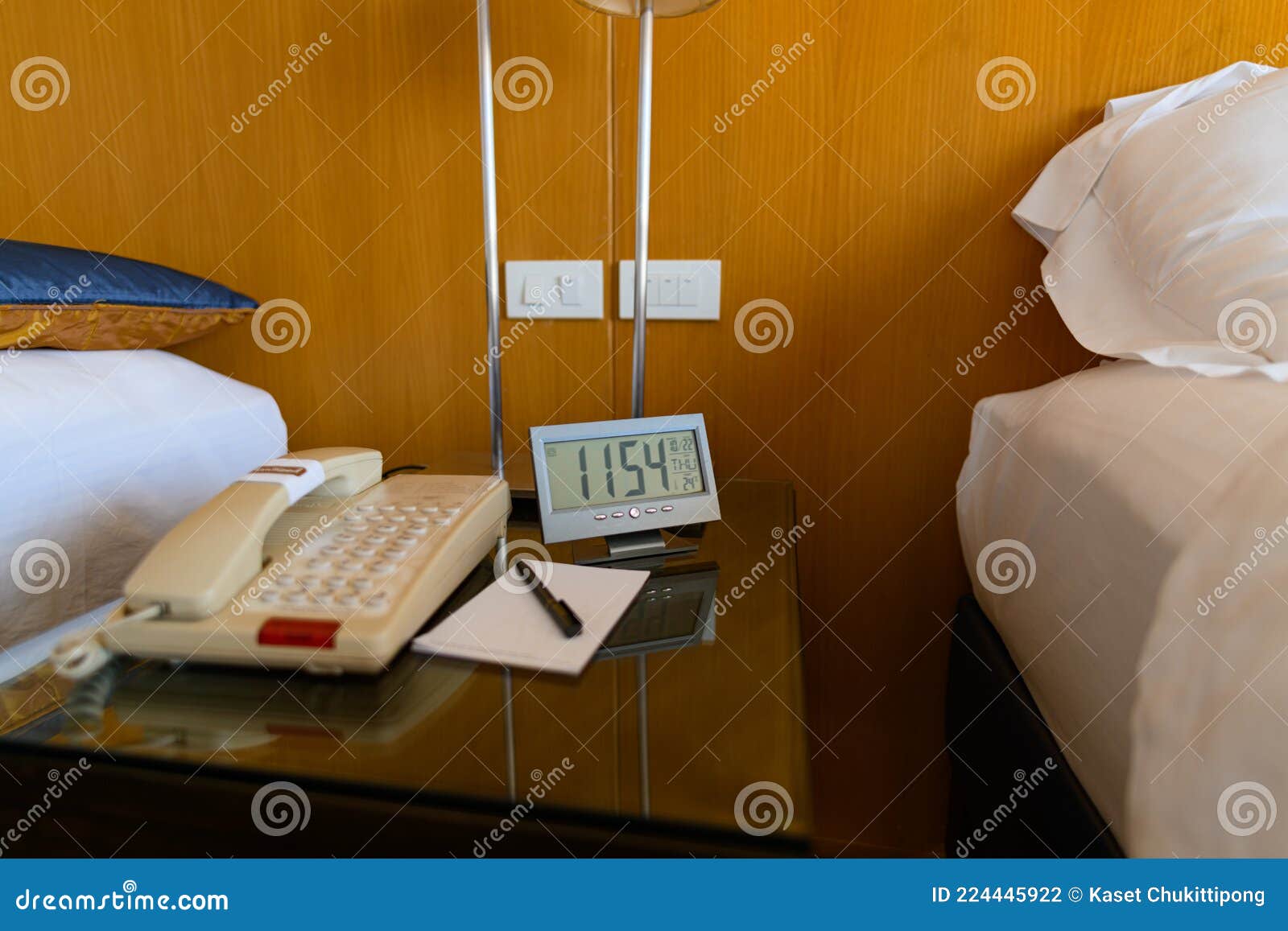 A Digital Clock is Placed on a Bedside Table with Wooden Walls Stock ...