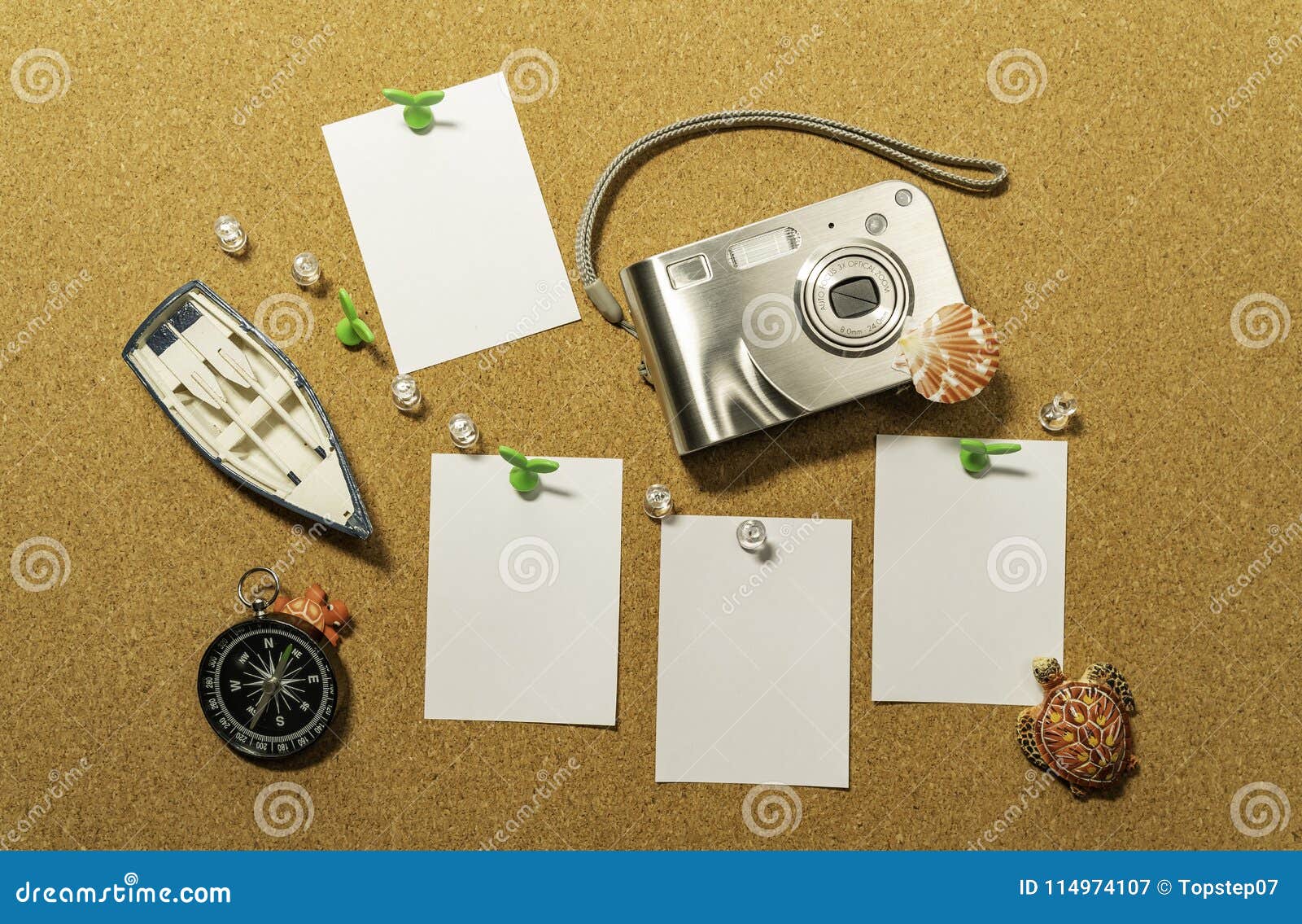 Digital Compact Camera on Cork Board with Blank White Paper, Compass ...