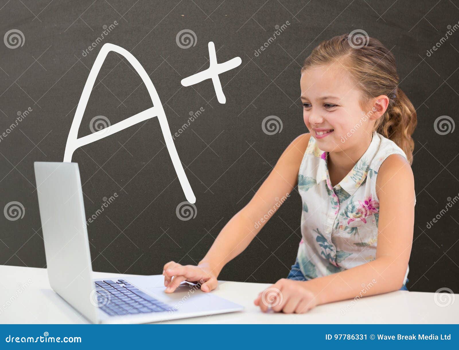 Happy Student Girl at Table Using a Computer Against Grey Blackboard ...