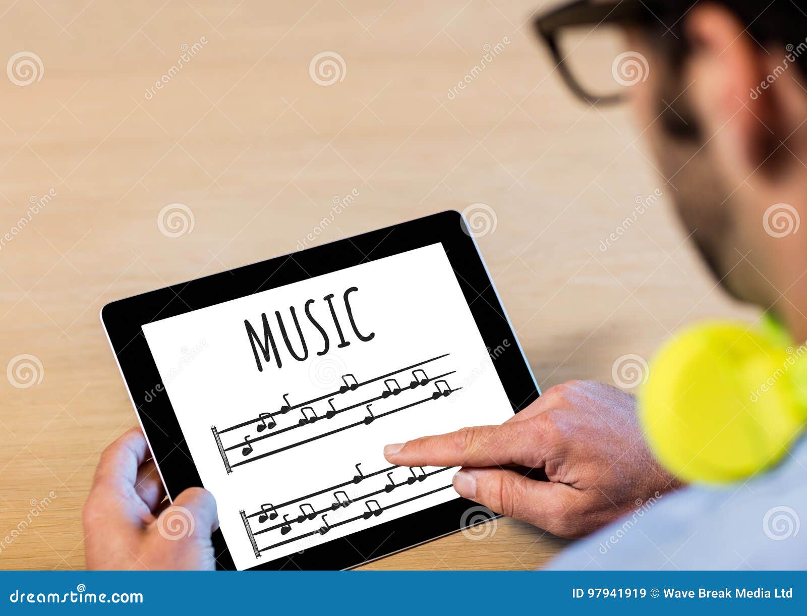 Music Notes on Tablet Screen with Mans Hands and Earphones Stock Image ...