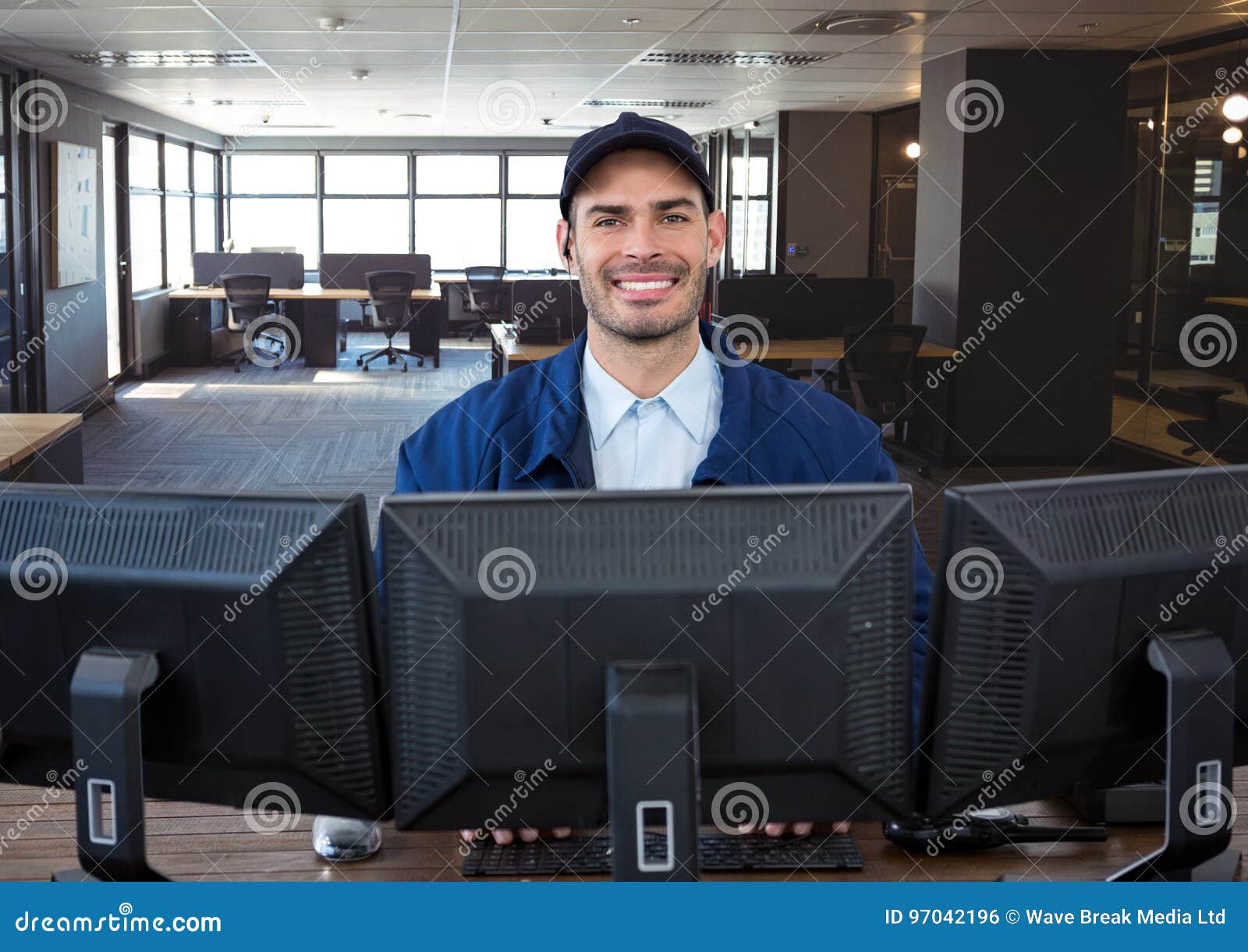 Security Guard Behind the Screens, Smiling. in the Office Stock Photo ...