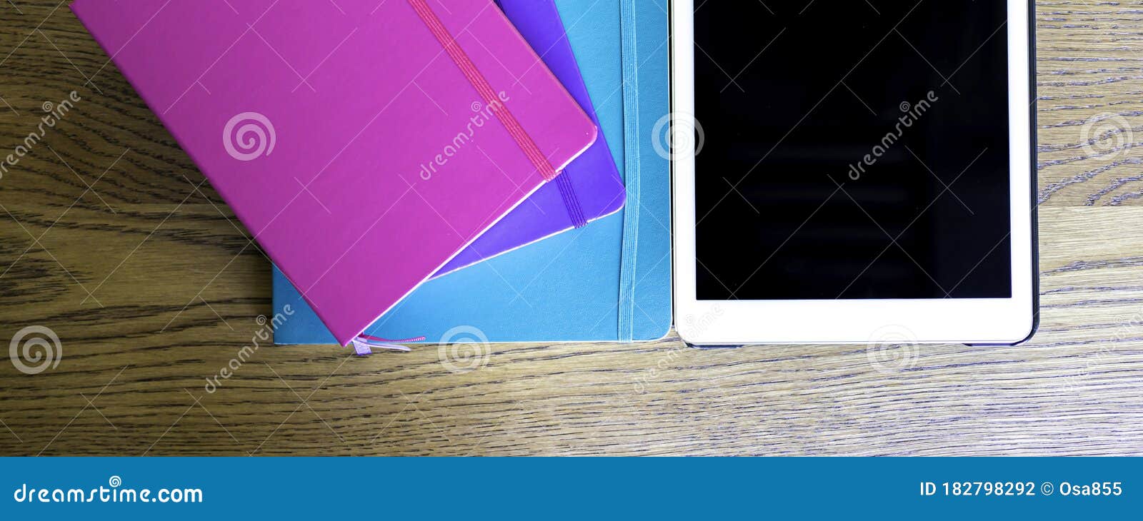 Digital Computer Tablet with a Collection of Multi Colored Notebooks ...