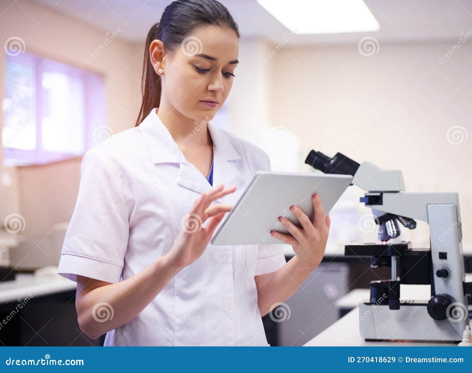 Digital Diagnostics. a Young Scientist Using a Digital Tablet while ...