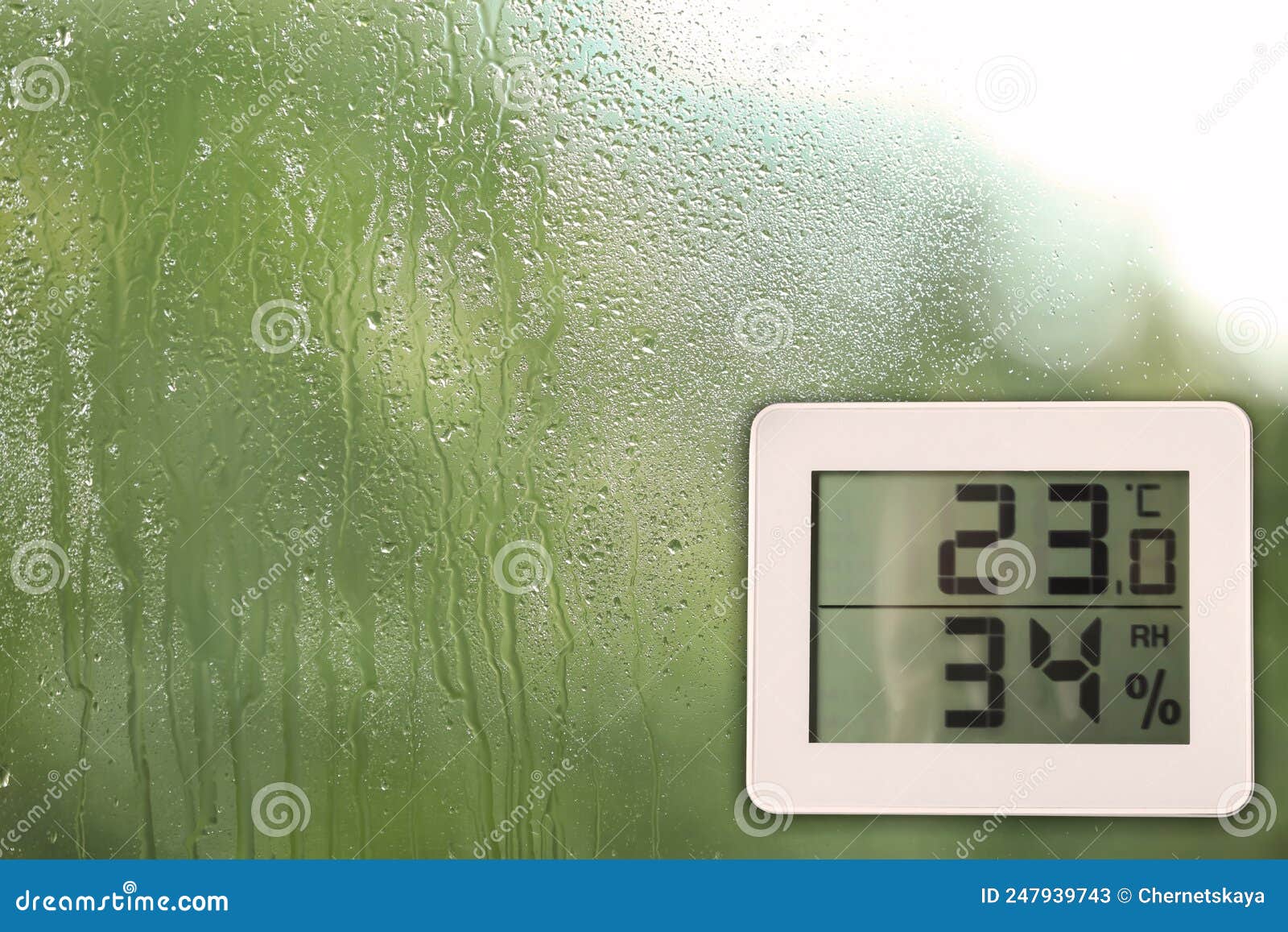Digital Hygrometer with Thermometer on Glass with Water Drops. Space ...