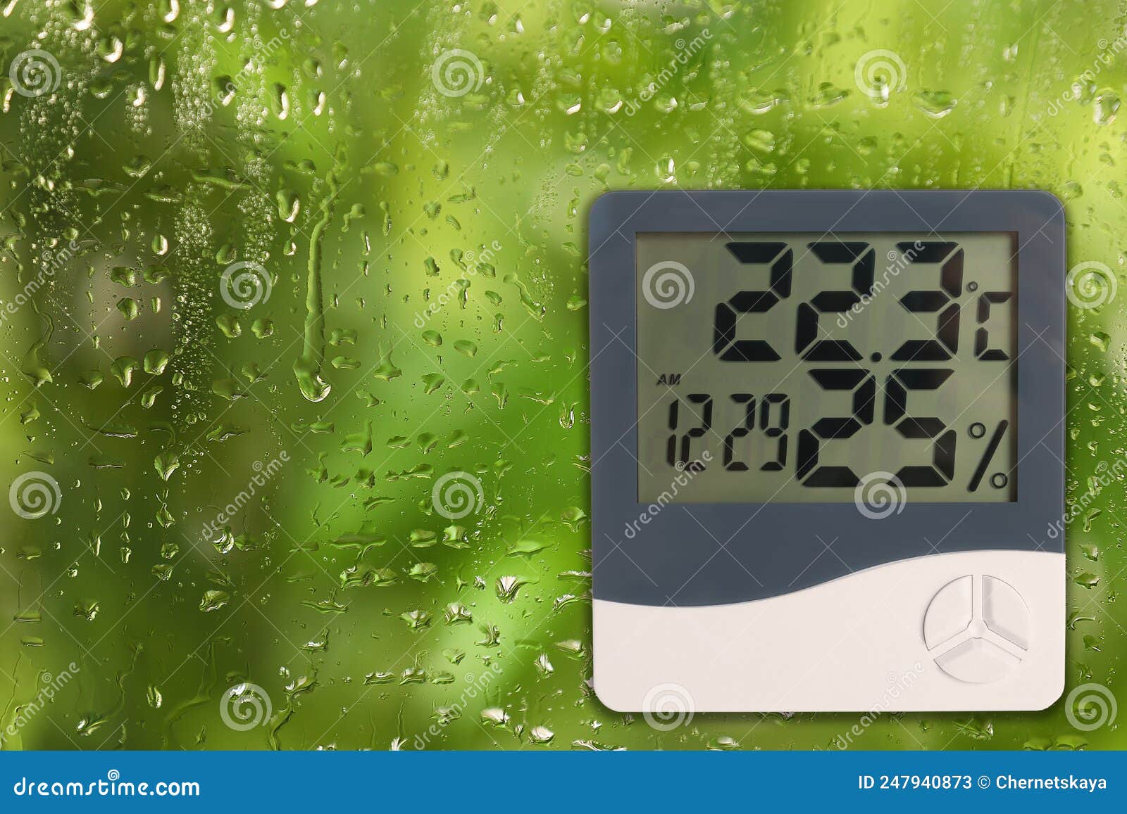 Digital Hygrometer with Thermometer on Glass with Water Drops. Space ...