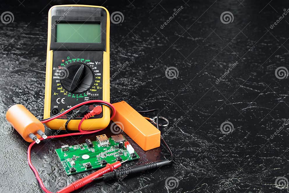 Digital Multi-meter with Probes on a Black Stone Background ...