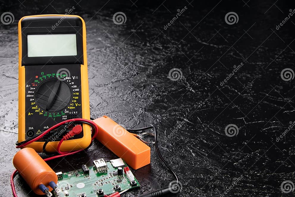 Digital Multi-meter with Probes on a Black Stone Background ...
