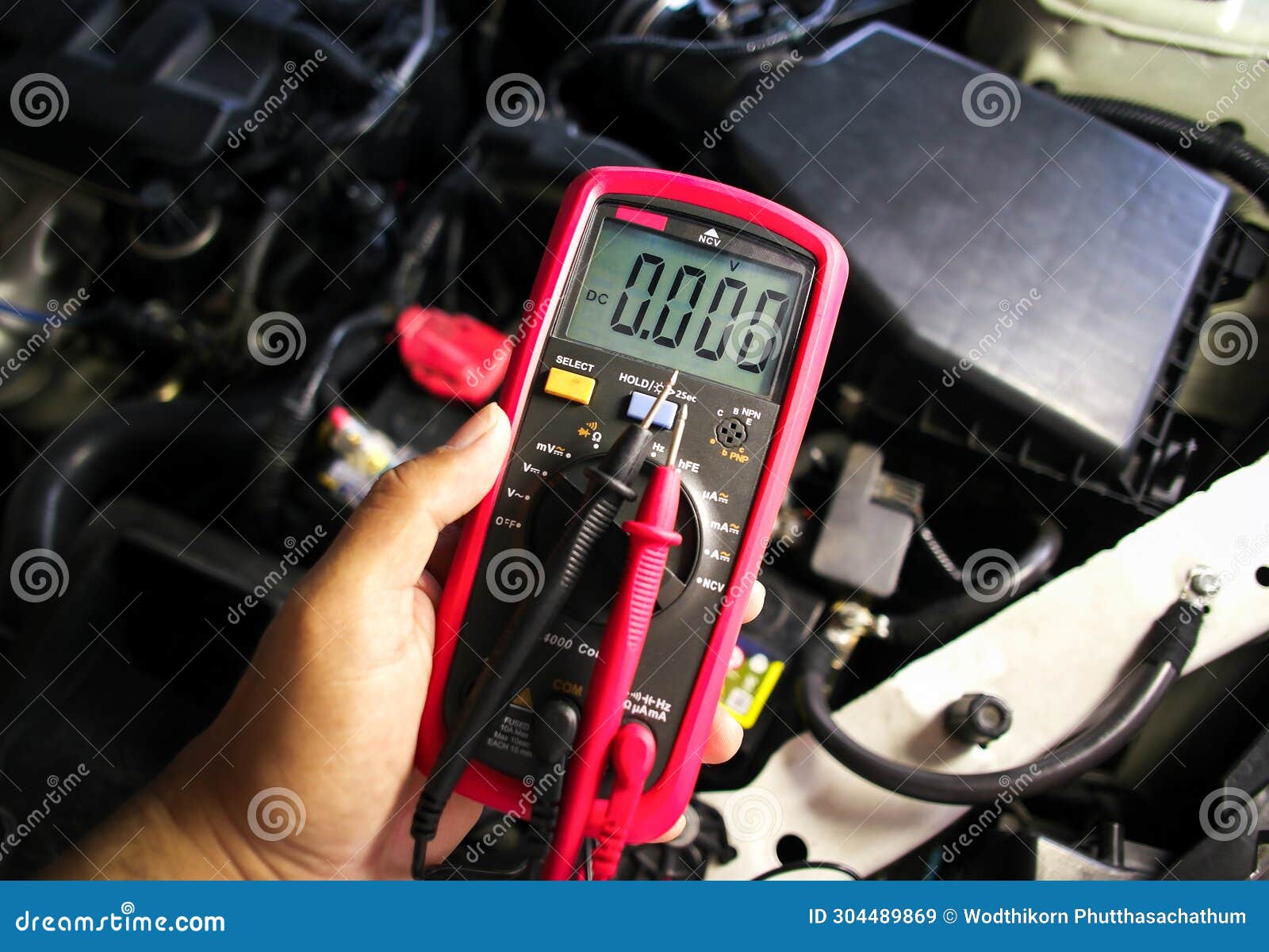 Digital Multimeter in the Hands of Mechanics for Measuring Car ...