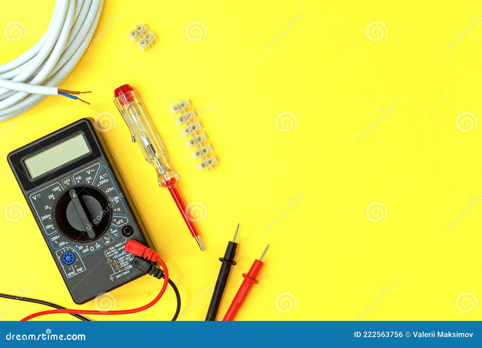 Digital Multimeter and Indicator Screwdriver on a Yellow Background ...