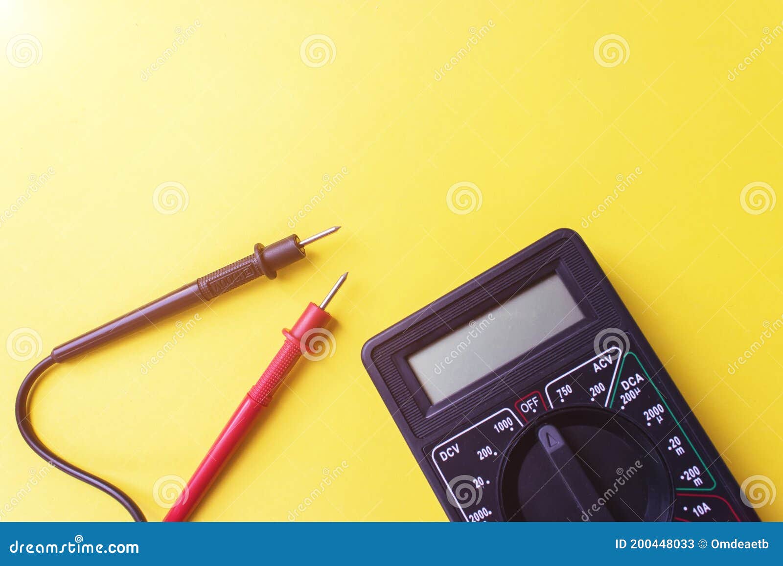 Digital Multimeter with Probes and Backlit Display on a Yellow ...