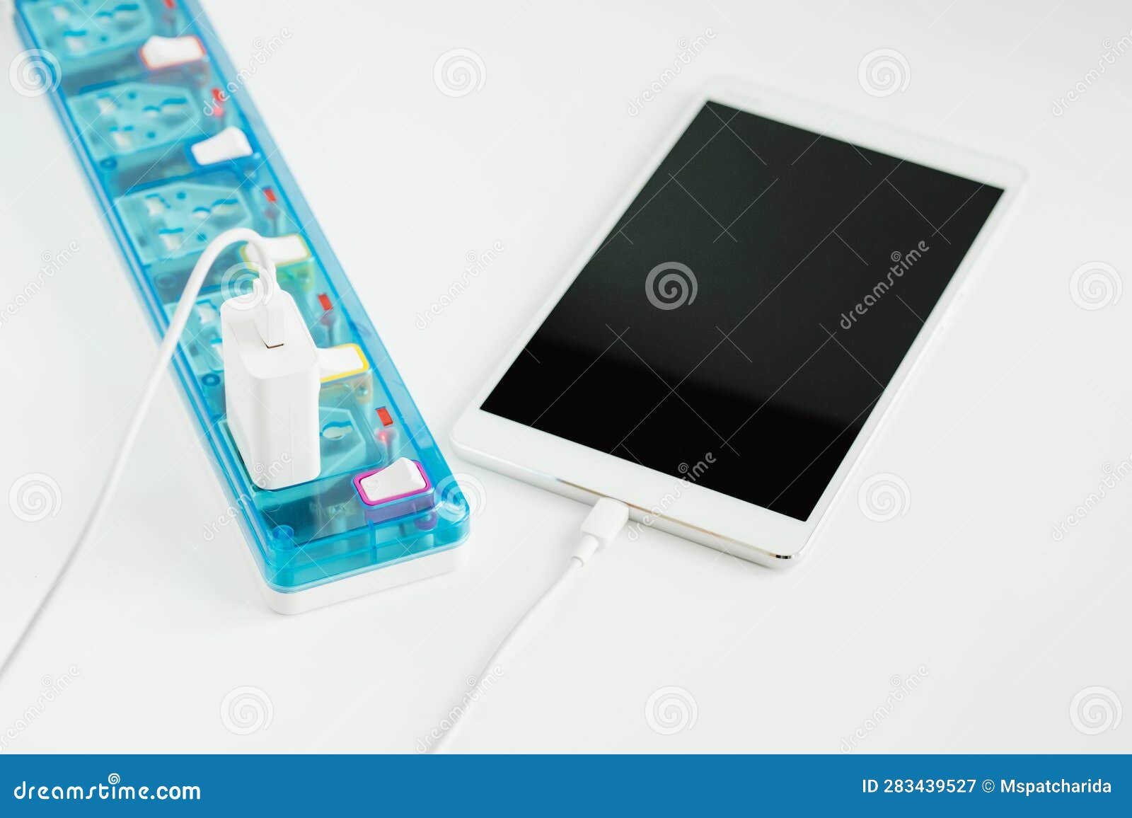 Digital Tablet is Charging with Extension Socket on White Background ...