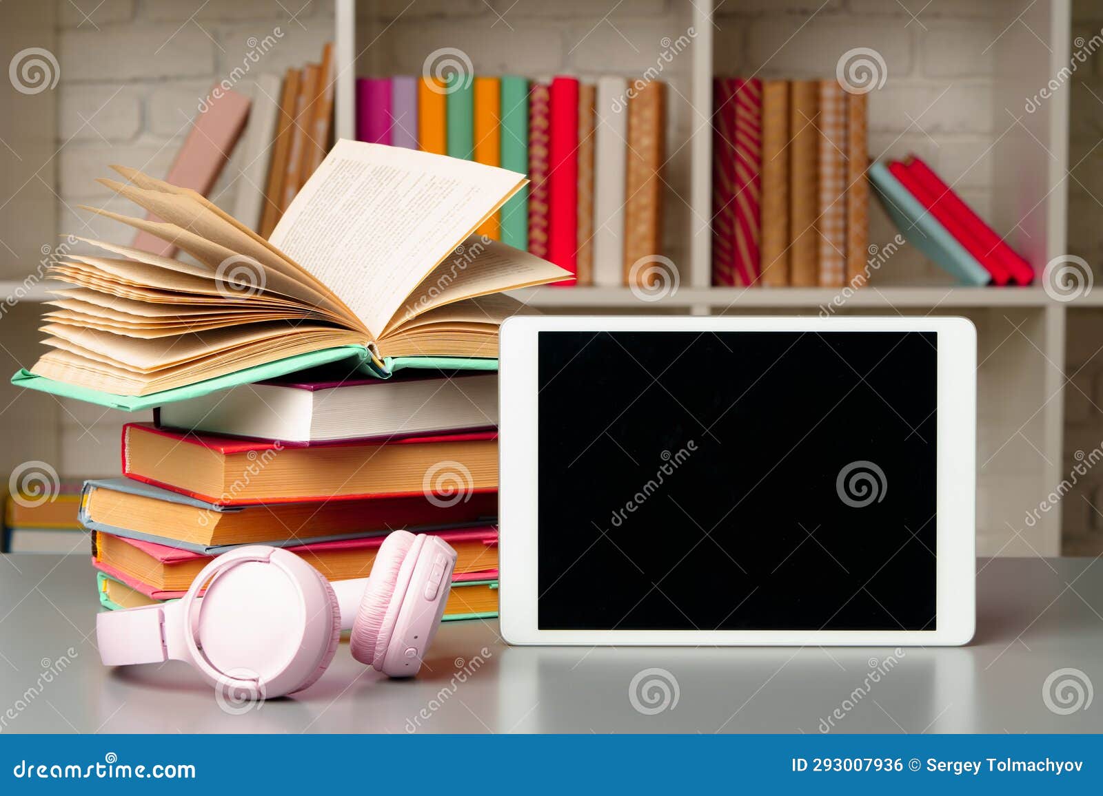 Digital Tablet with Stacked Books in Library Stock Photo - Image of ...