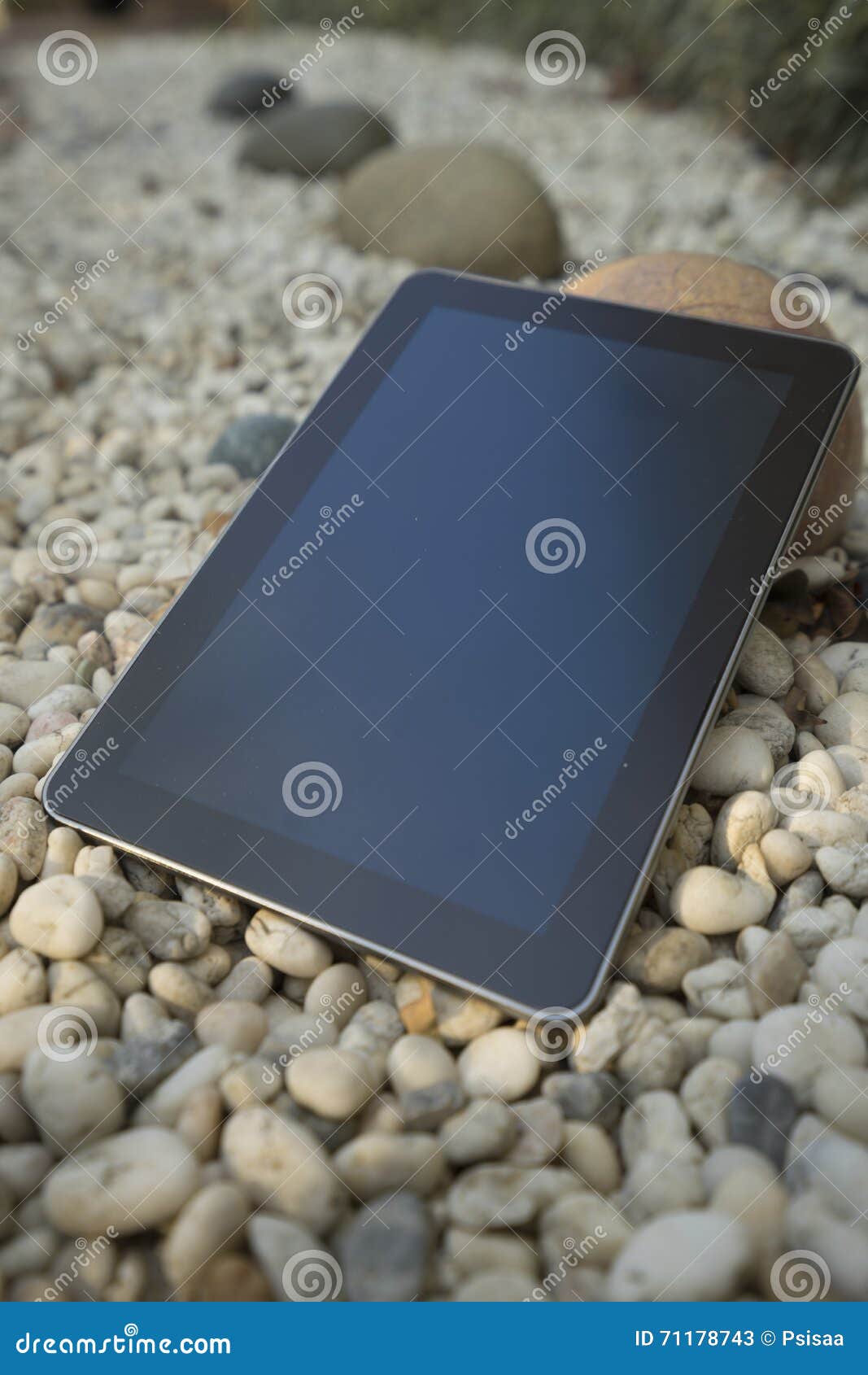 Digital tablet on stone stock image. Image of screen - 71178743