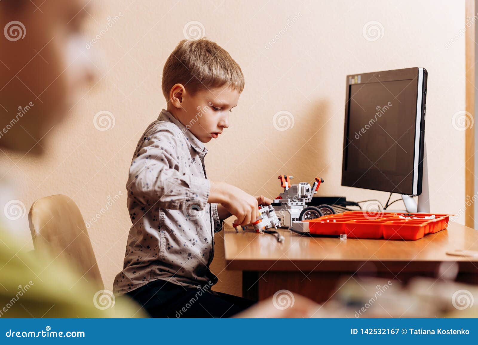 Diligent Boy Dressed in Gray Shirt Makes a Robot from the Robotic ...