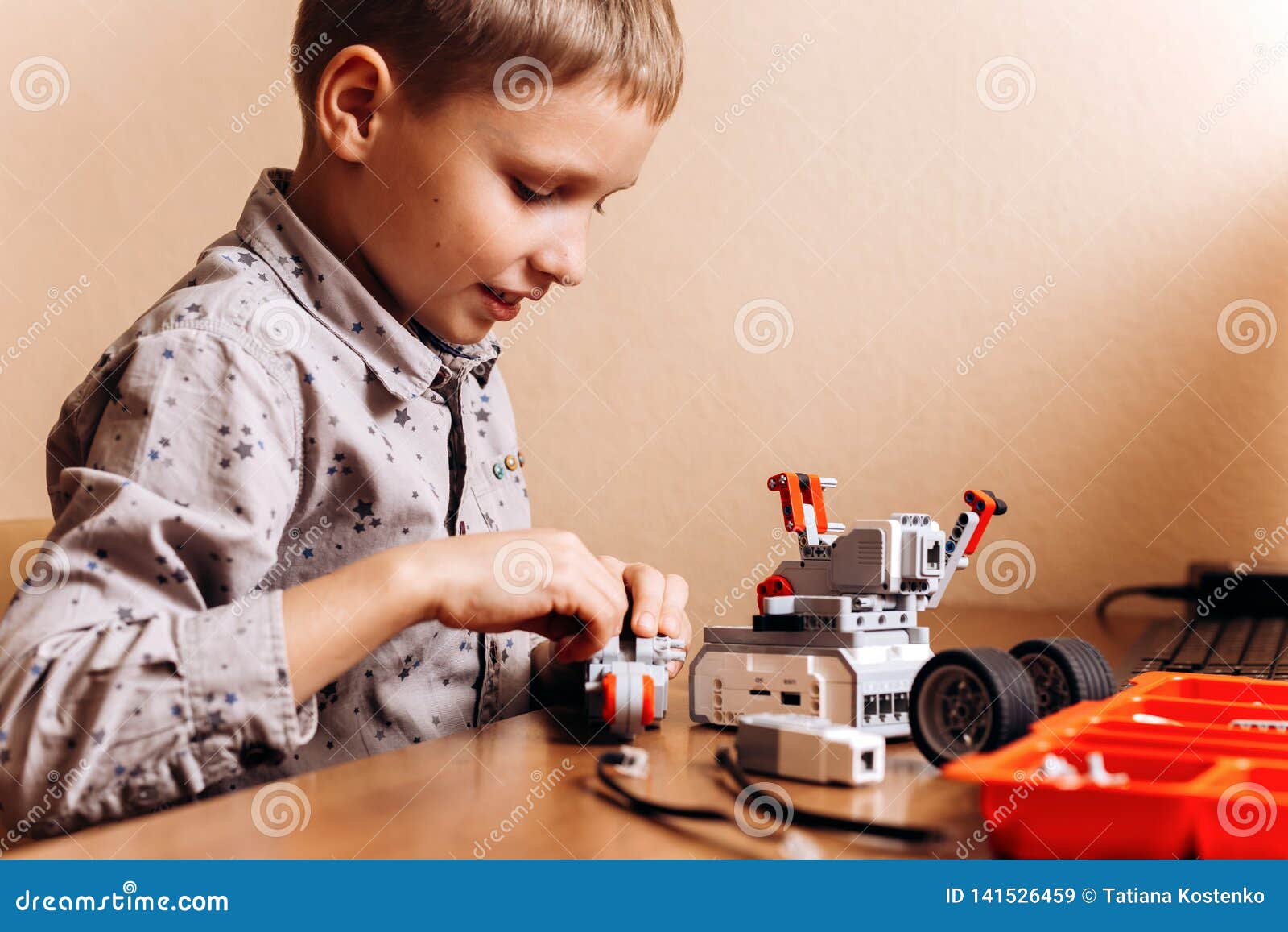 Diligent Boy Dressed in Gray Shirt Makes a Robot from the Robotic ...